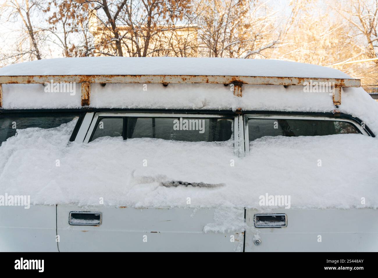 the car is covered with snow. the car after the blizzard Stock Photo - Alamy