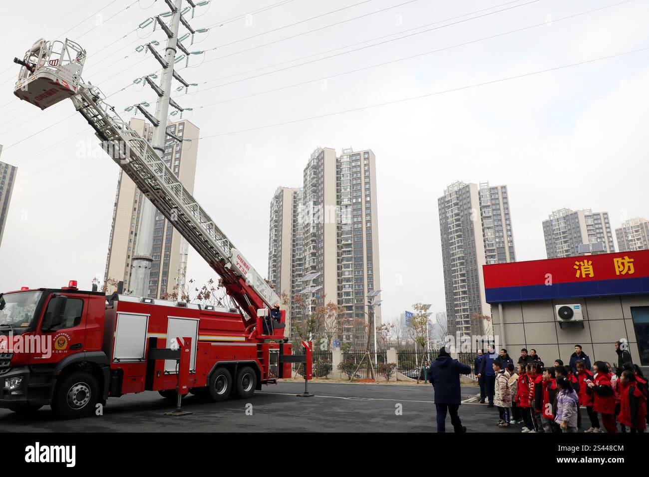 Students experience an aerial ladder fire truck under the guidance of ...