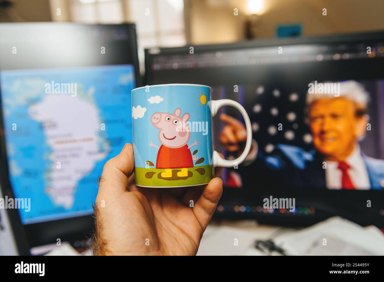 Paris, France - Jan 1, 2025: A hand holding a Peppa Pig-themed mug in ...