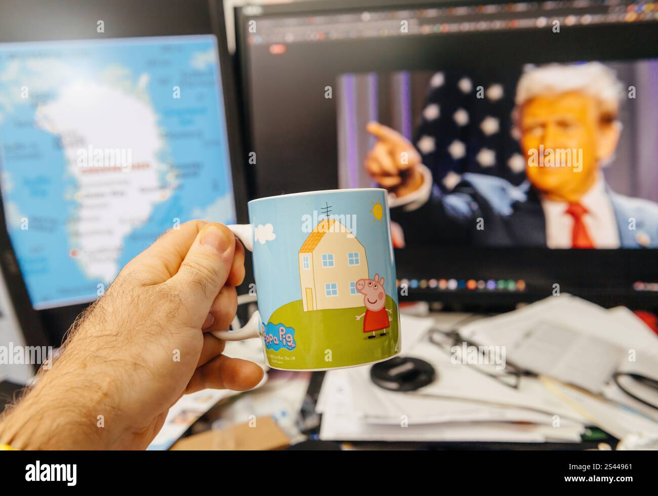 Paris, France - Jan 1, 2025: A hand holding a Peppa Pig-themed mug in ...