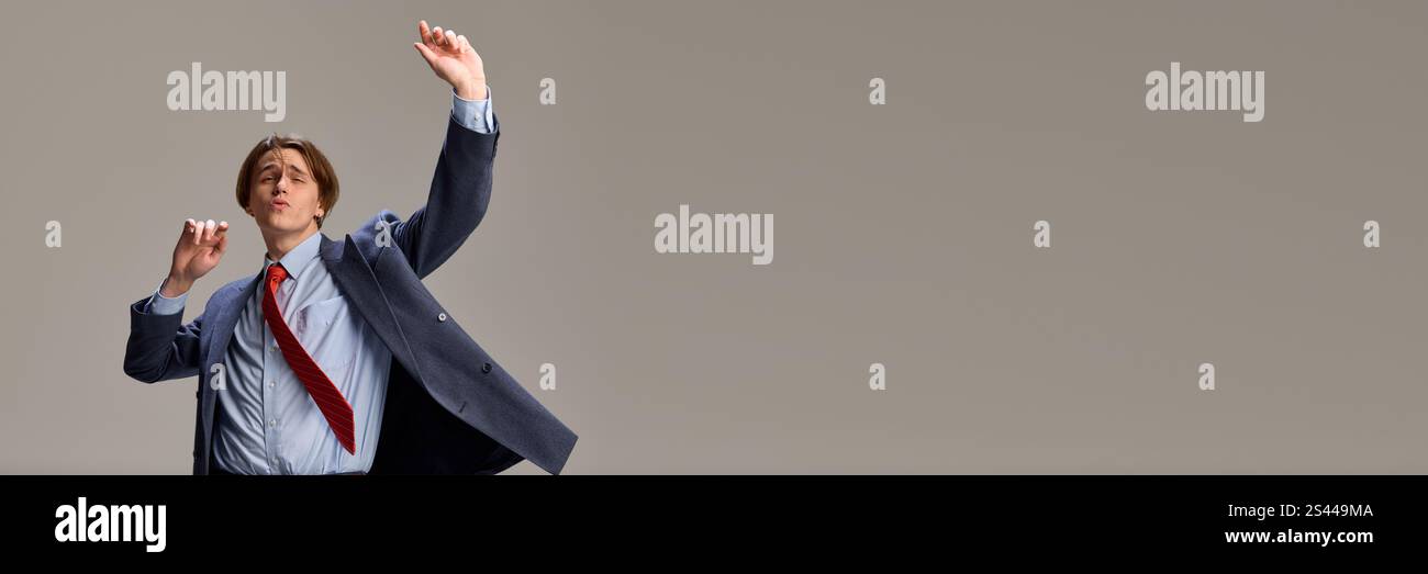 Banner. Successful happy young man dancing, raising hands with joy ...