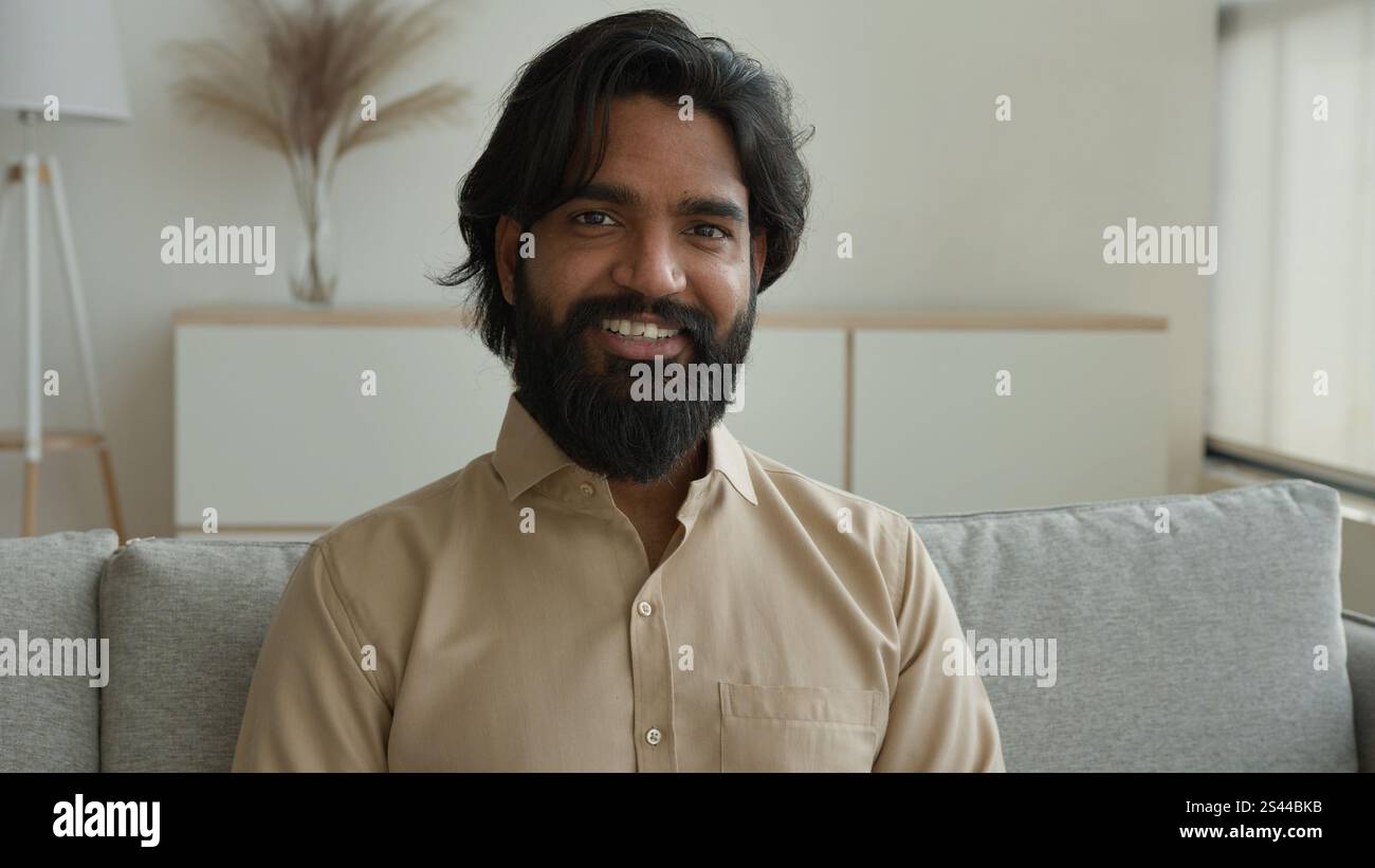 Portrait happy joyful Arabian muslim man guy Indian muslim businessman at home office male ...