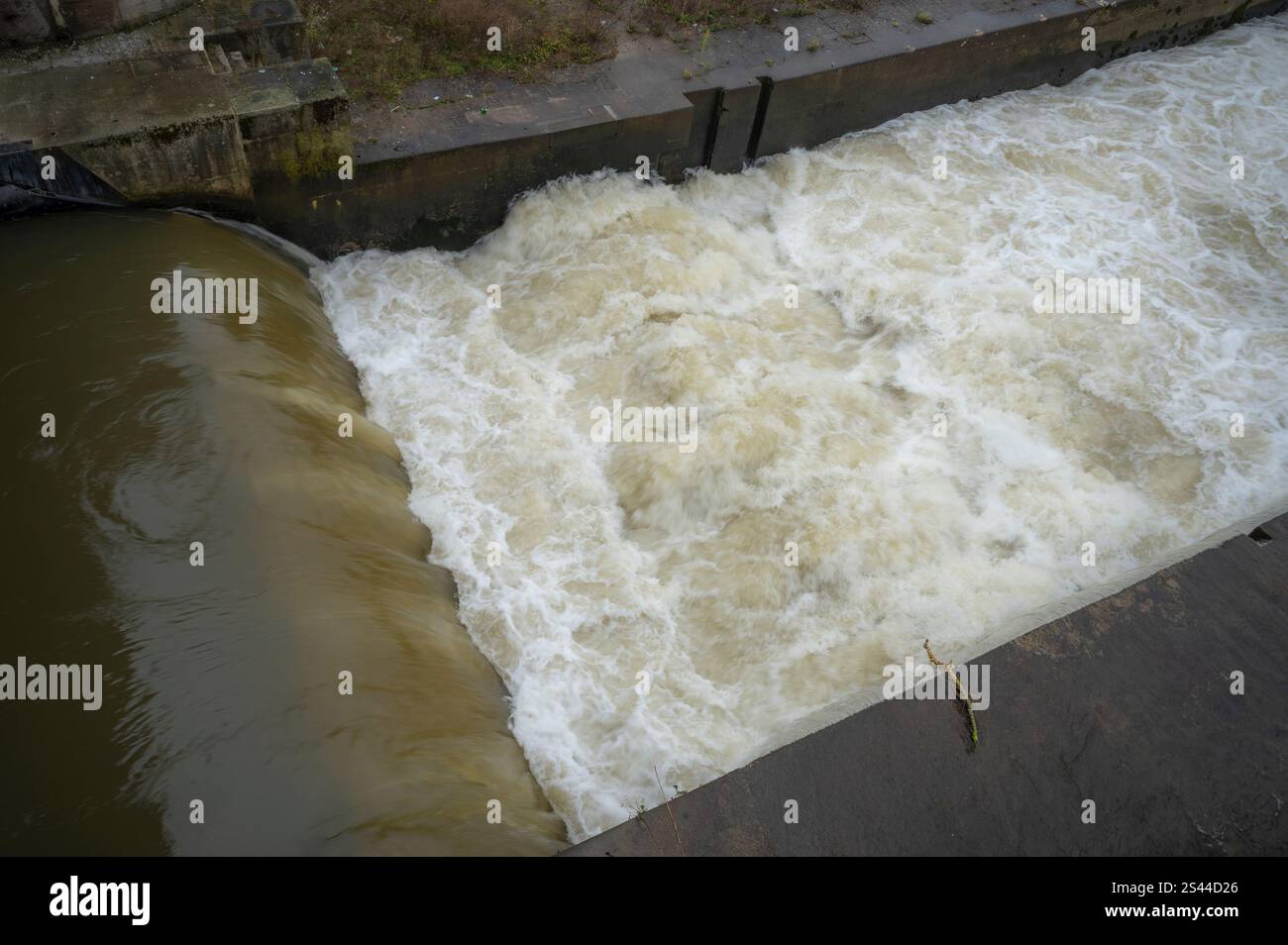 A powerful river rushing over a dam. The force of the water is truly ...