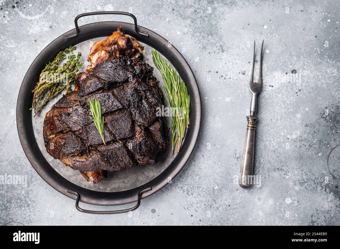 Slow cooked venison roast leg. Braised game meat of deer with bone ...