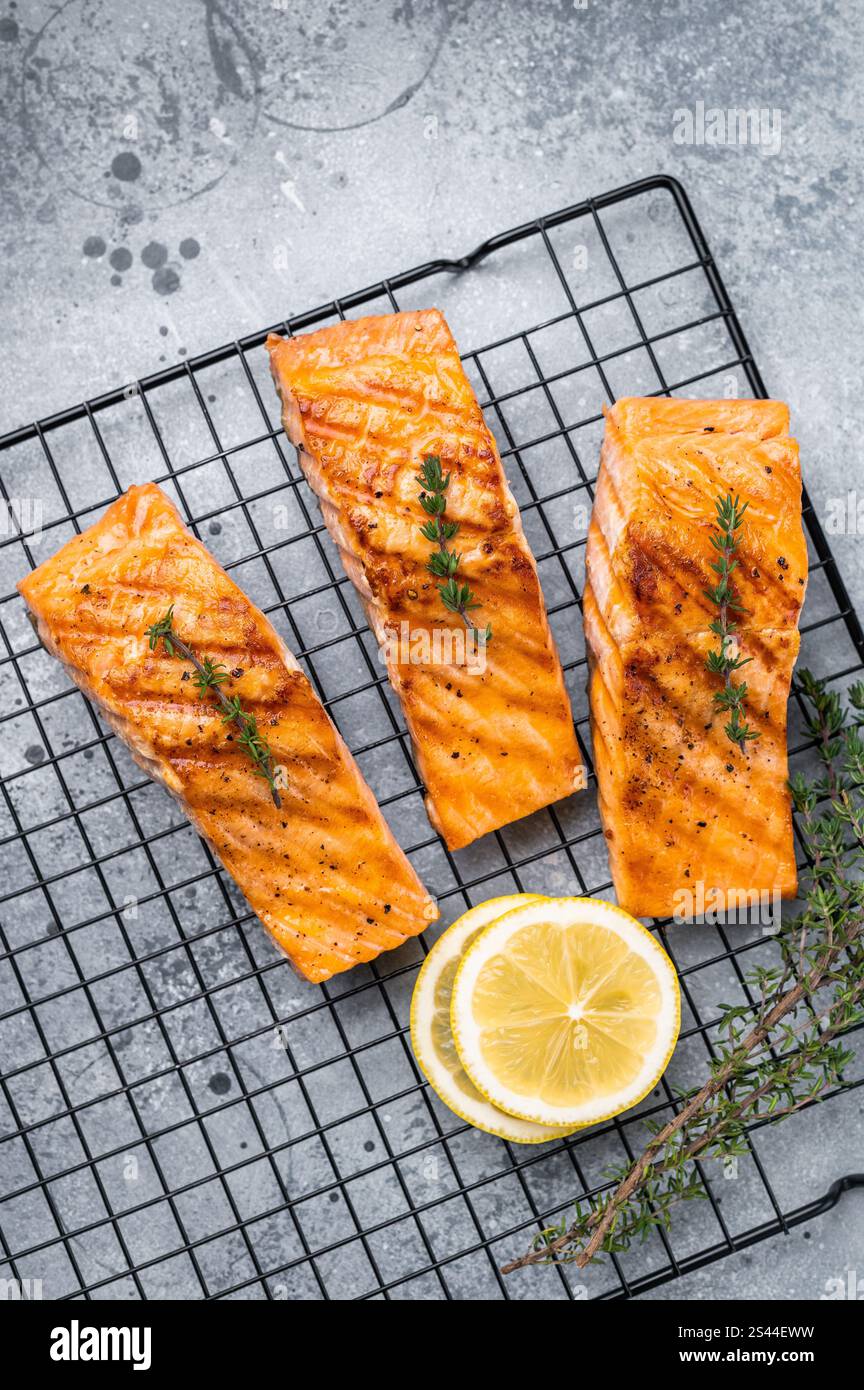 Grilled salmon fillet steak, roast fish on a rack. grey background. top ...