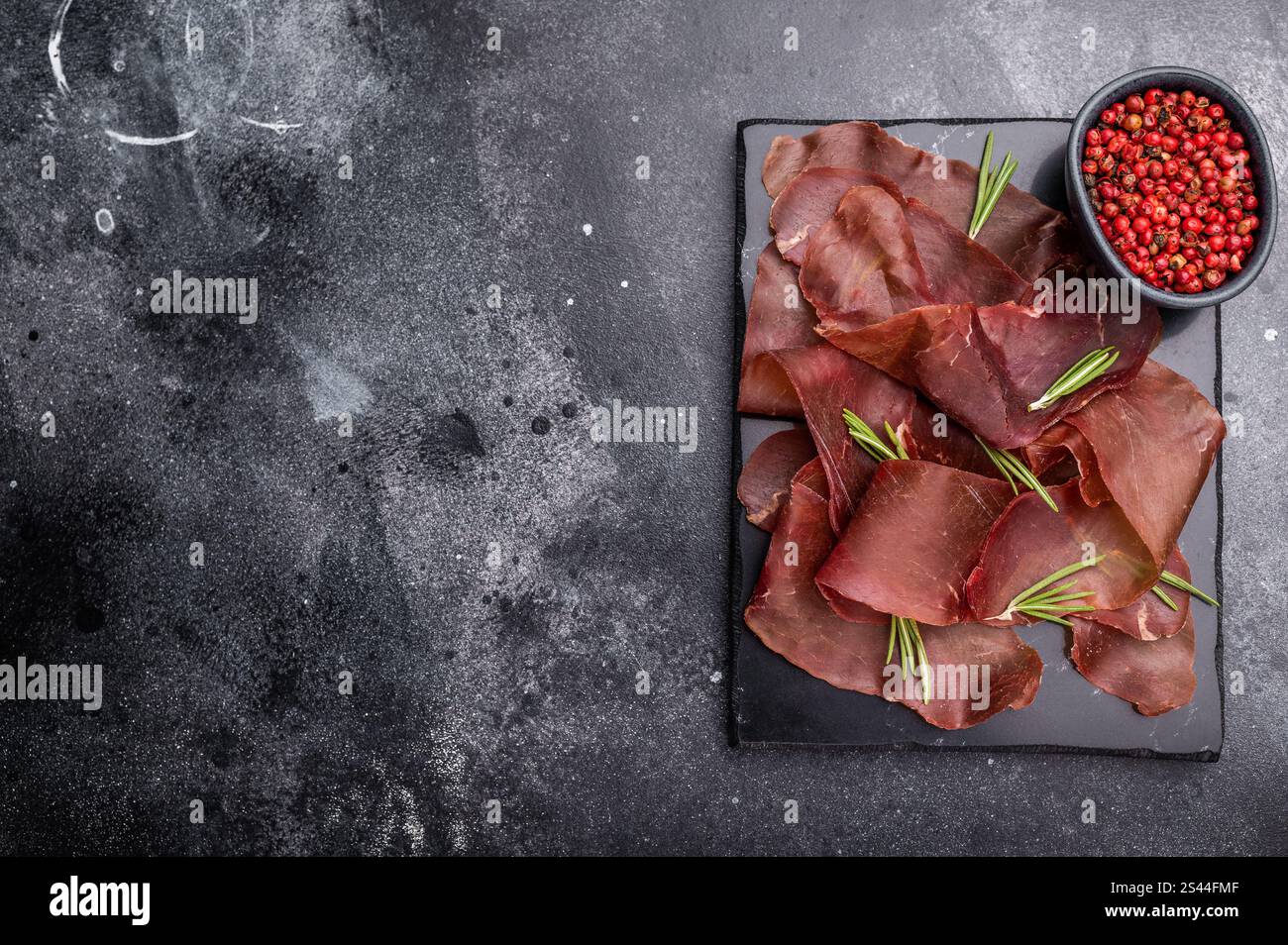Dried spanish meat slices cecina, spanish tapa. black background. top ...