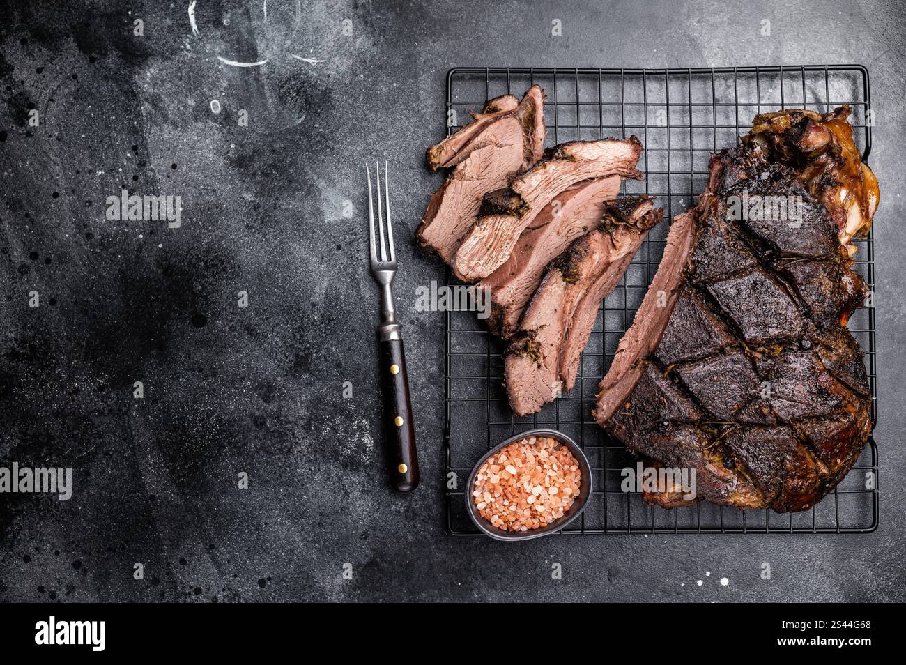 Roasted Roe Deer leg. slow cooked game meat of venison with bone. black ...