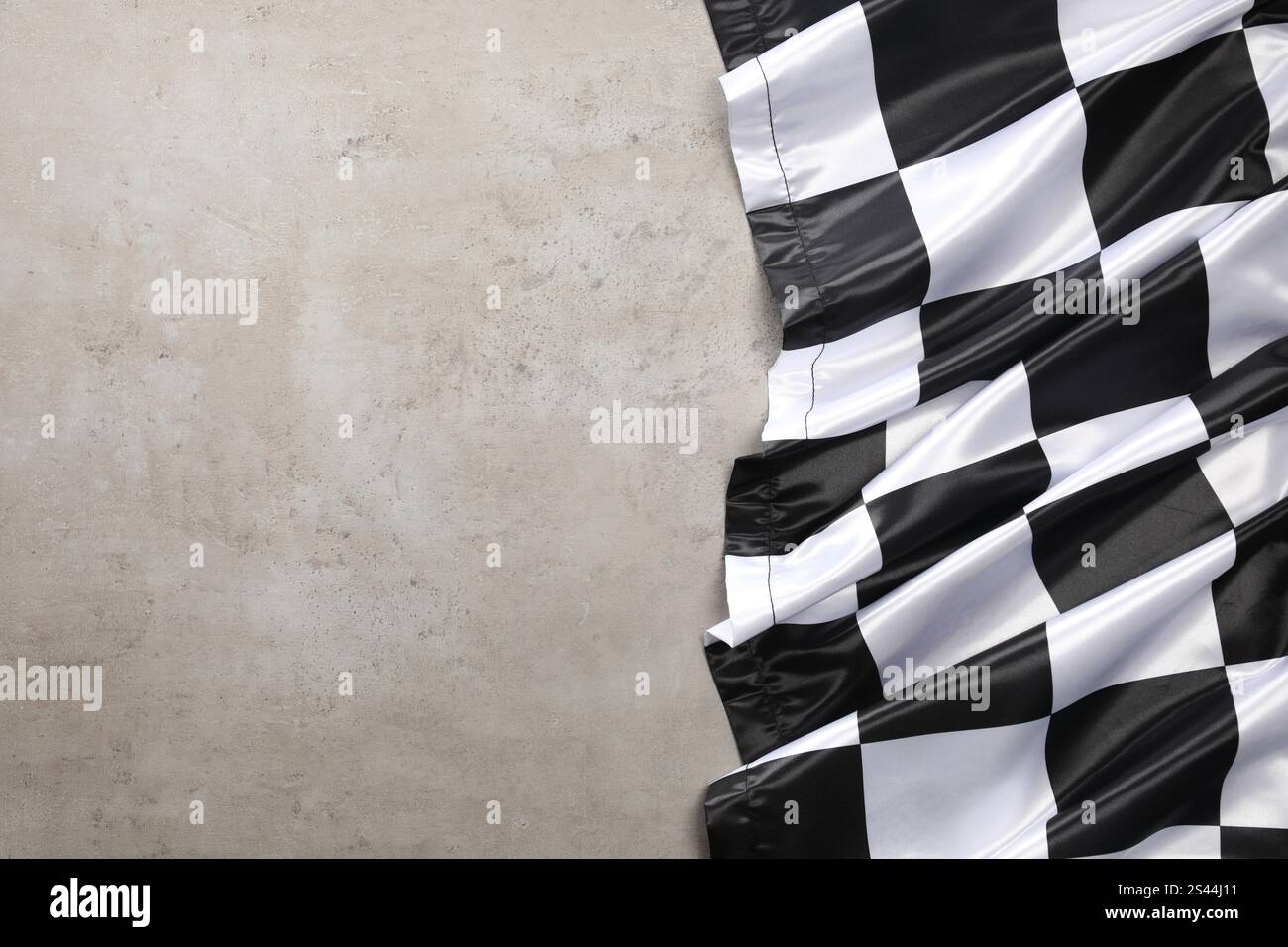Checkered flag on grey table, top view. Space for text Stock Photo - Alamy
