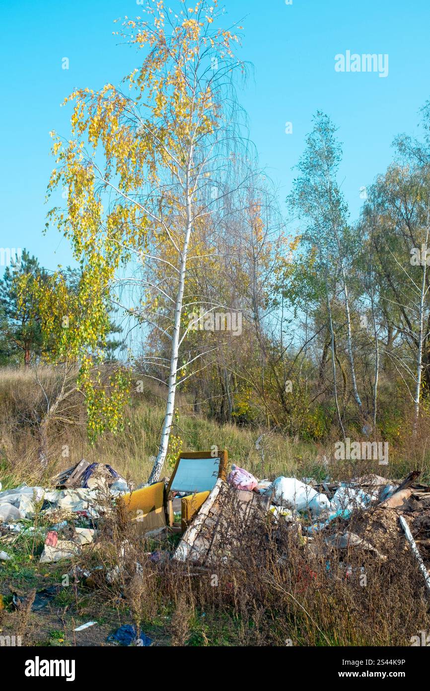 polluted area with trash and debris scattered around a field, including ...