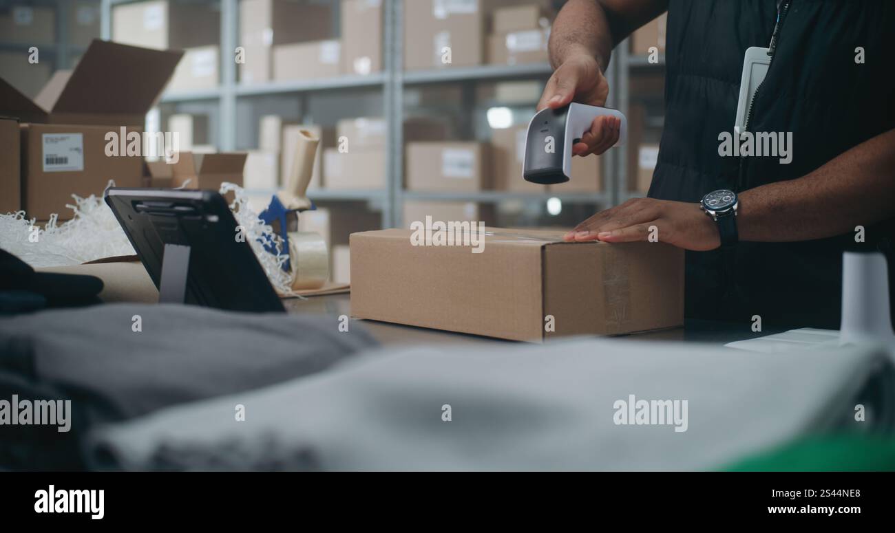 Close Up of African American Postal Worker, Shipping Clerk Packing ...