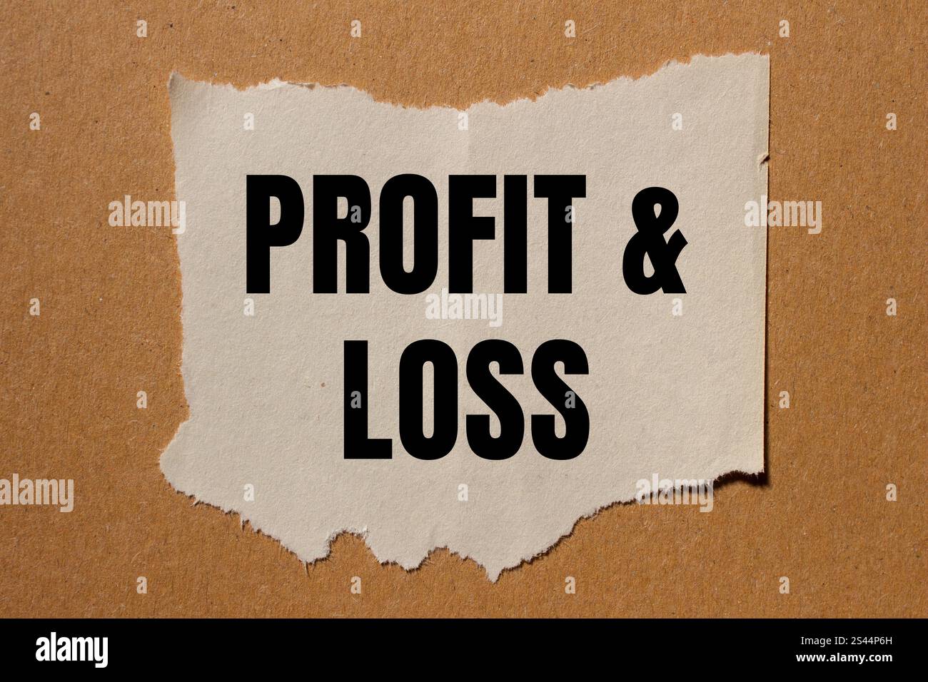 Profit and loss message written on ripped torn paper piece with brown ...