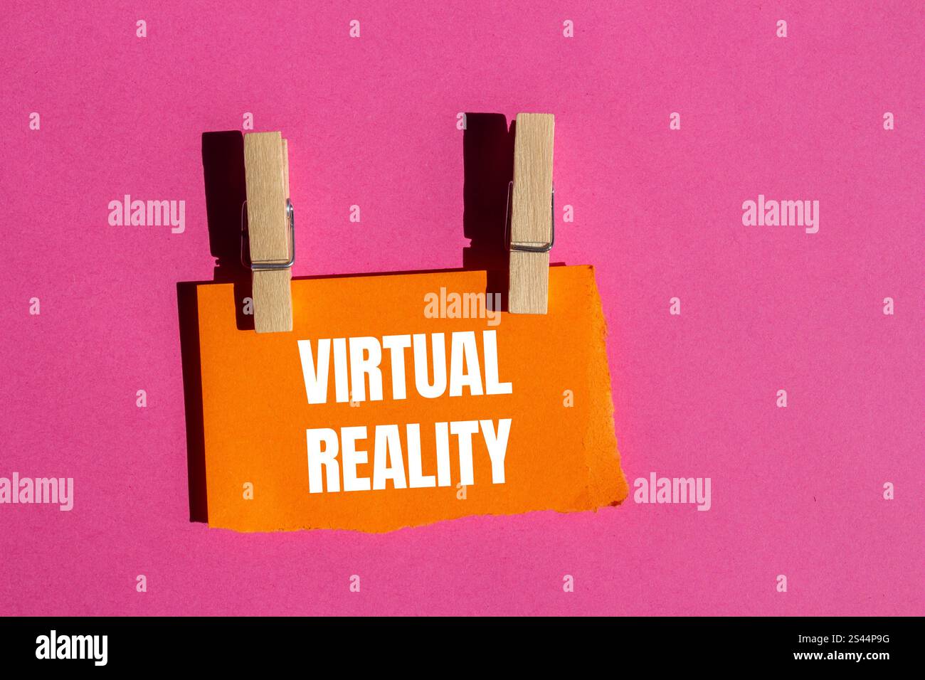 Virtual reality message written on ripped torn orange paper piece with ...