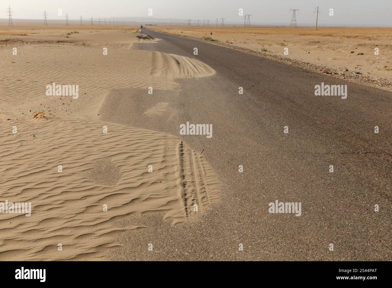 A winding road cuts through a vast, sandy terrain in Kunduz Province ...