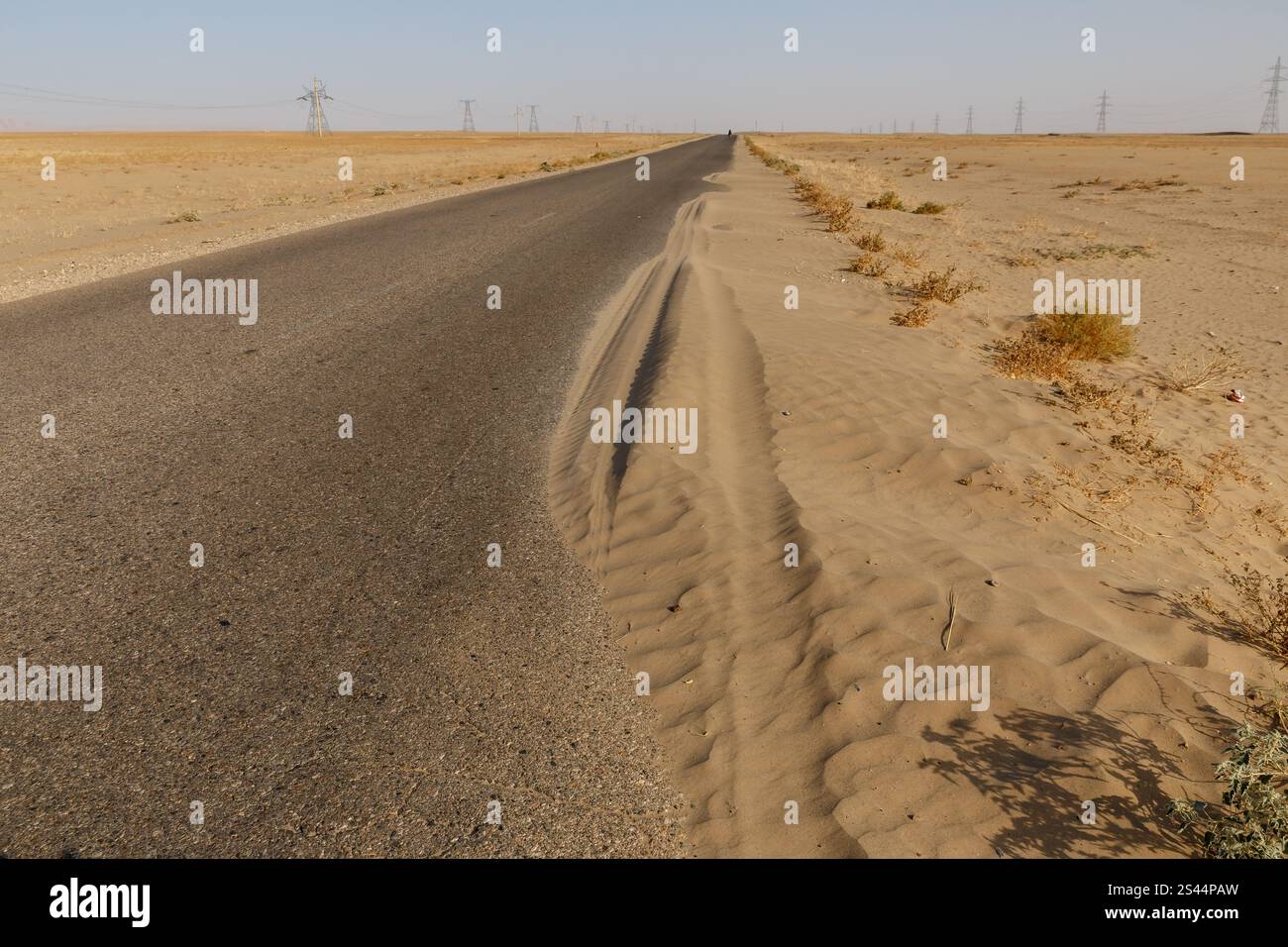 A deserted road stretches through Kunduz Province, Afghanistan, with ...