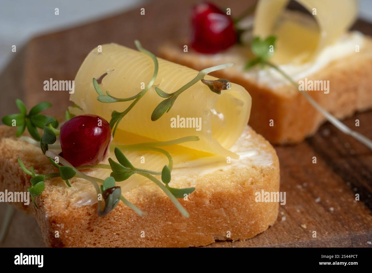 Mini toast with butter, cheese and watercress microgreens. Macro and ...