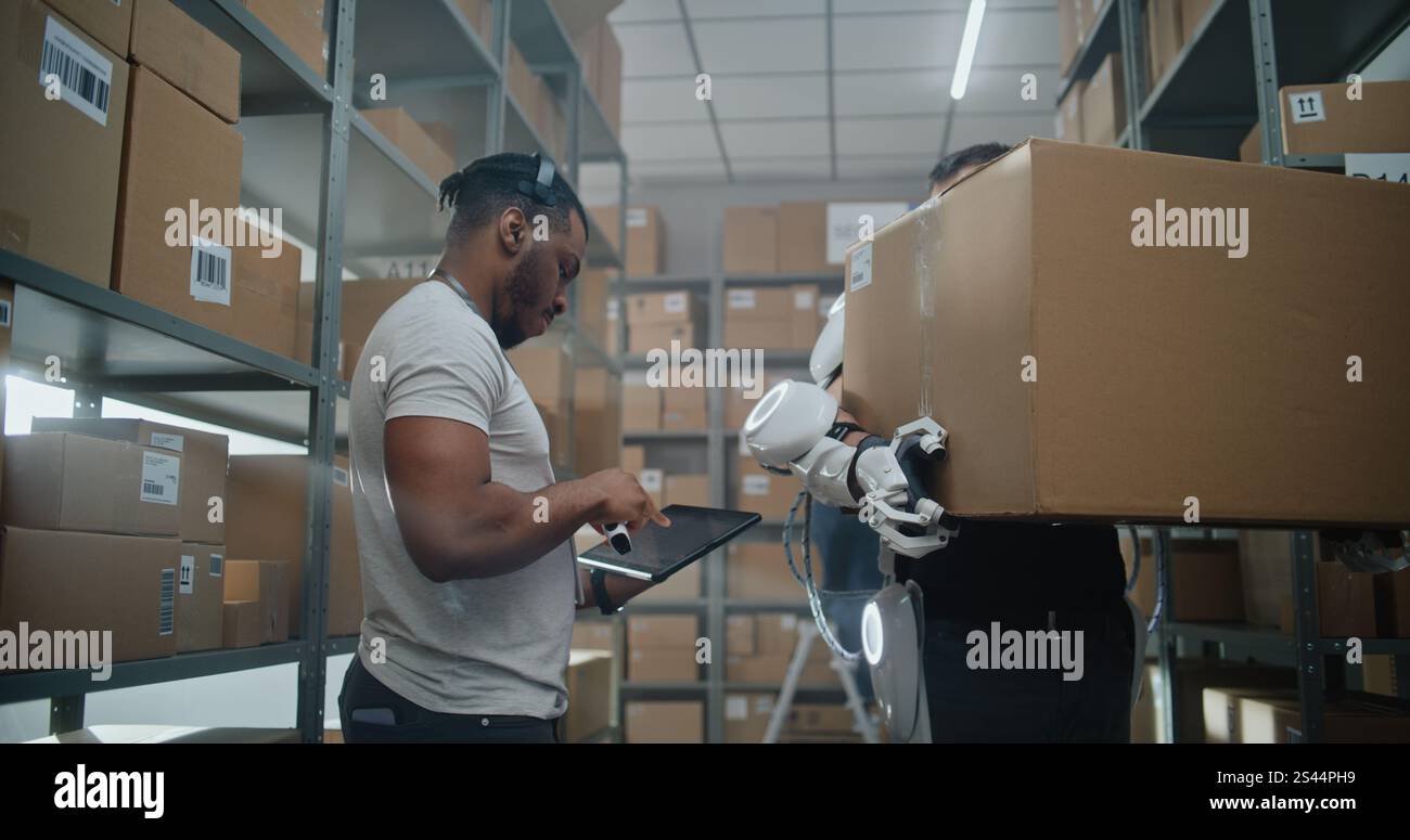High-Tech Advanced Warehouse: African American Manager Wearing Headset ...
