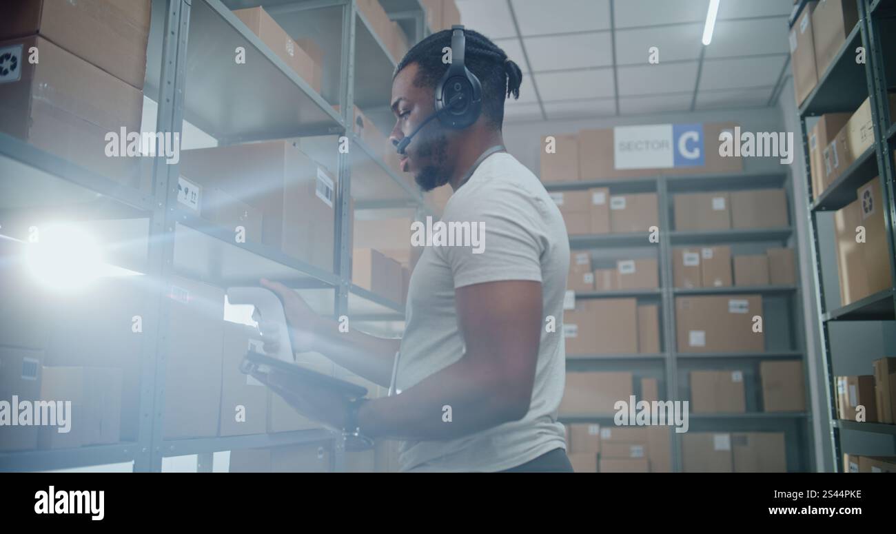 Advanced Warehouse: African American Manager Wearing Headset Scans ...