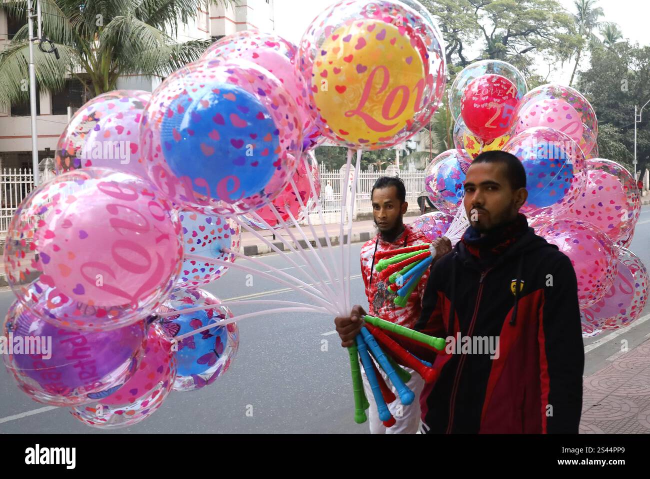 Dhaka, Dhaka, Bangladesh. 10th Jan, 2025. Two balloon sellers walk the ...