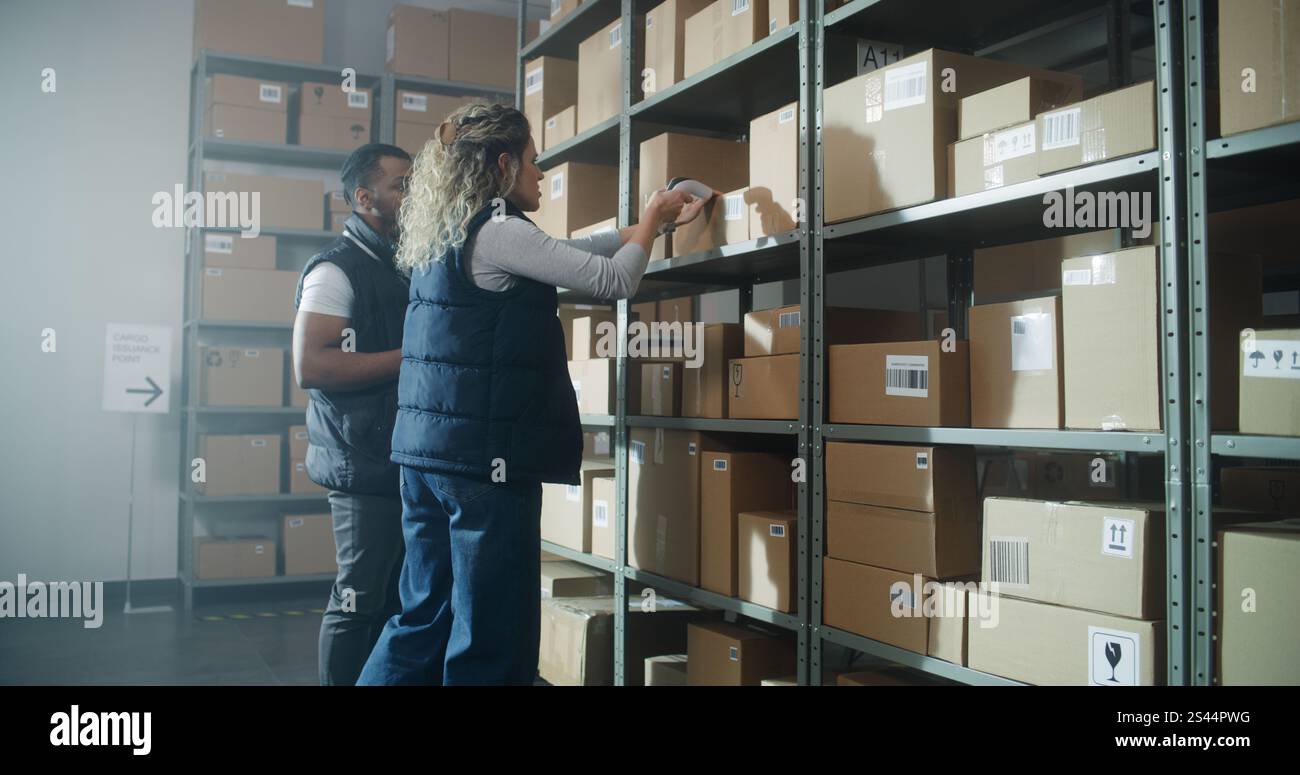 Multiethnic Warehouse Workers Using Tablet Computer, Having Discussion ...