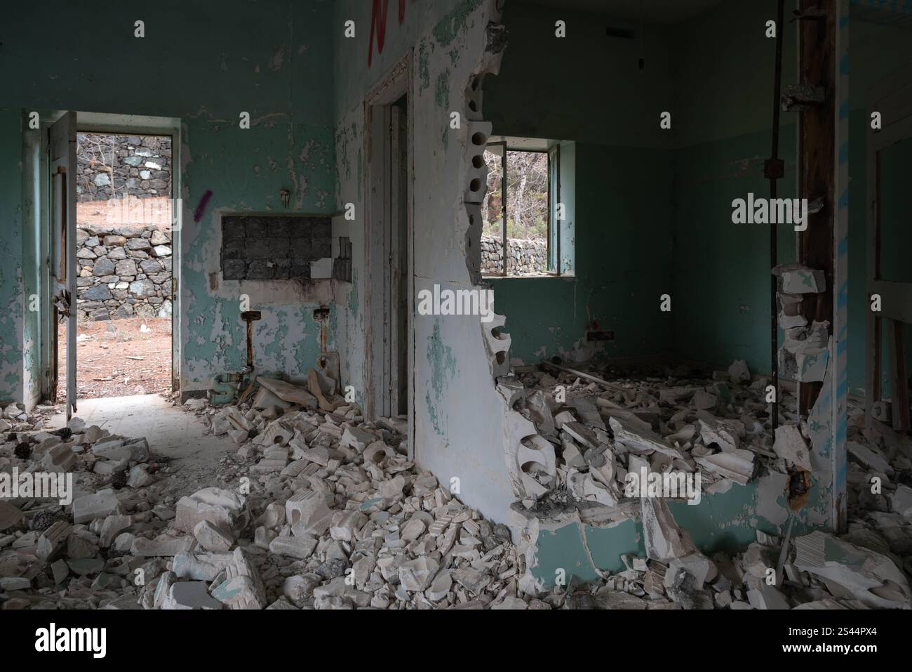 Interior of a decaying room filled with construction debris, featuring ...