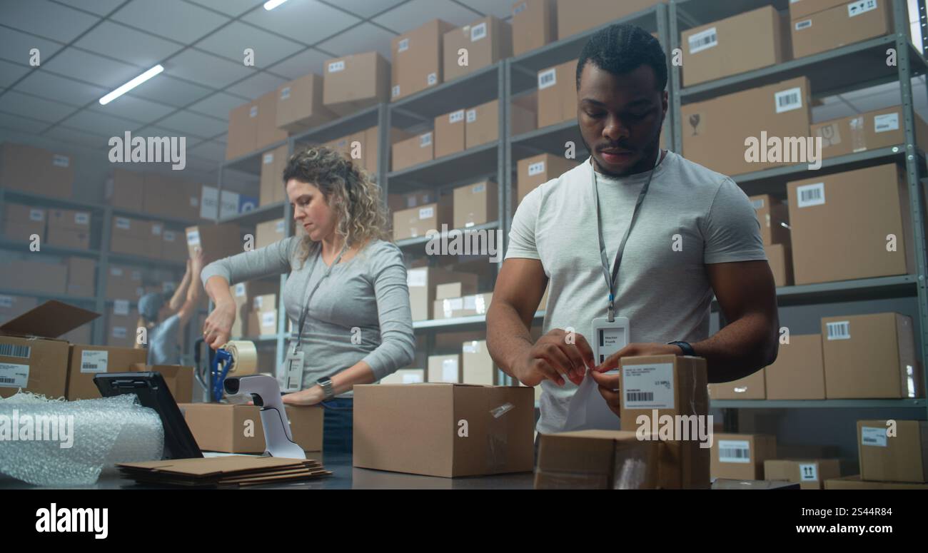 Multiethnic Warehouse Workers Packing Cardboard Parcels with Online ...
