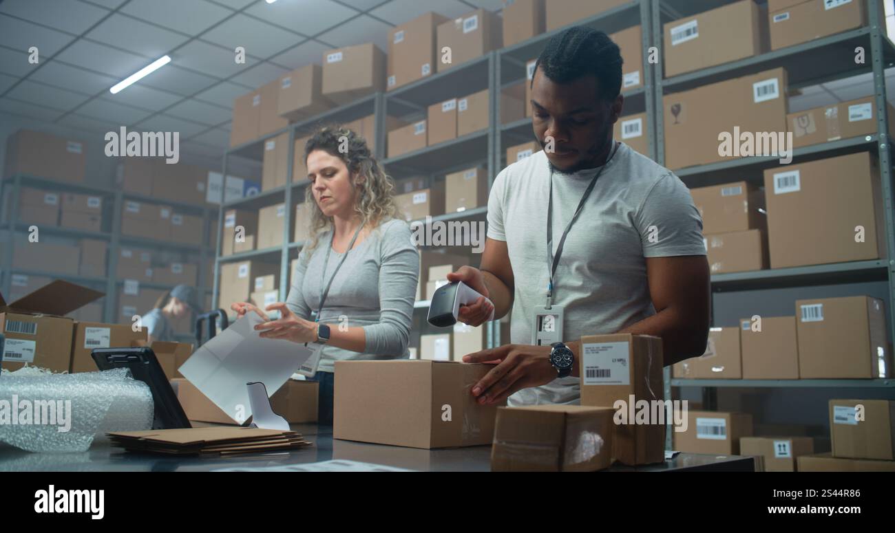 Multiethnic Warehouse Workers Packing Cardboard Parcels with Online ...
