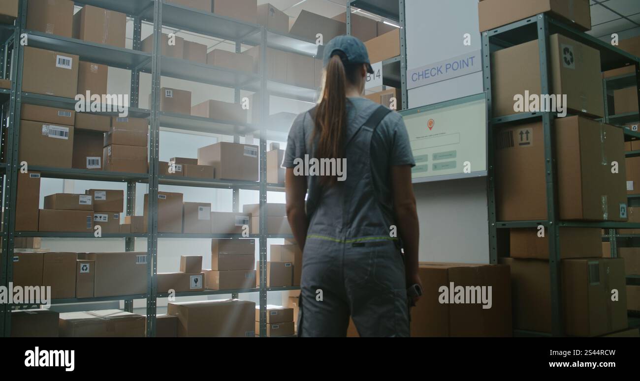 High-Tech Advanced Sorting Center: Warehouse Worker in Futuristic Full ...
