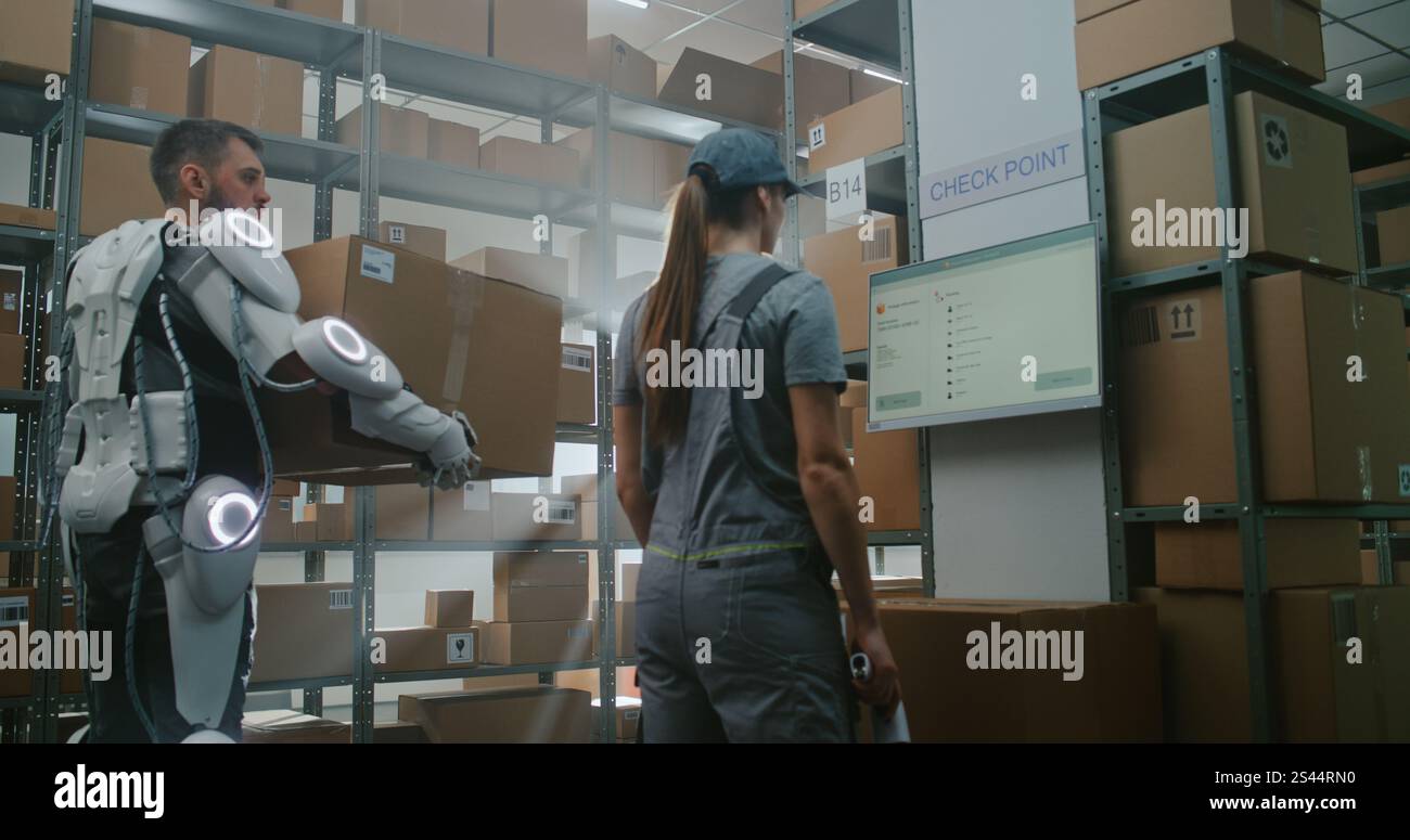 High-Tech Advanced Sorting Center: Warehouse Worker in Futuristic Full Body Robotic Exoskeleton ...