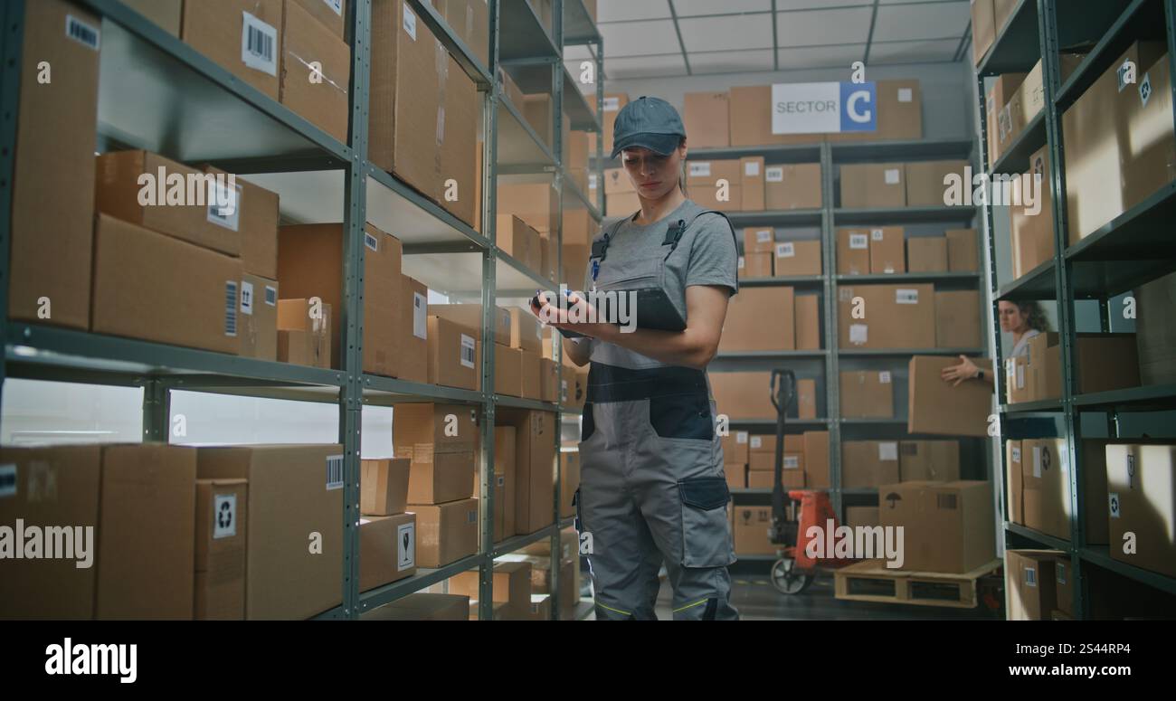 High-Tech Advanced Warehouse: Sorting Center Worker Wearing Futuristic Full Body Powered ...