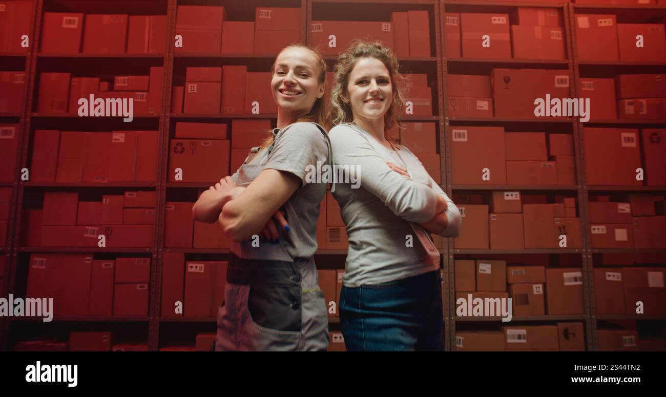 Two Female Warehouse Workers Standing with Crossing Arms, Smiling ...