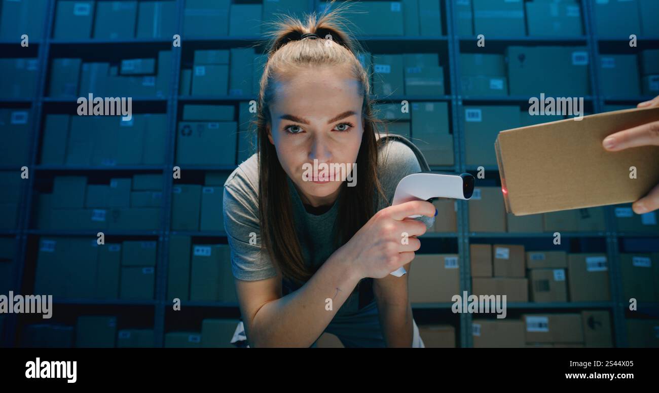Exhausted Female Warehouse Worker Looking at Camera, Scanning Parcels ...