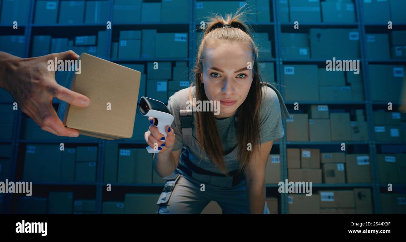 Exhausted Female Warehouse Worker Looking at Camera, Scanning Parcels ...