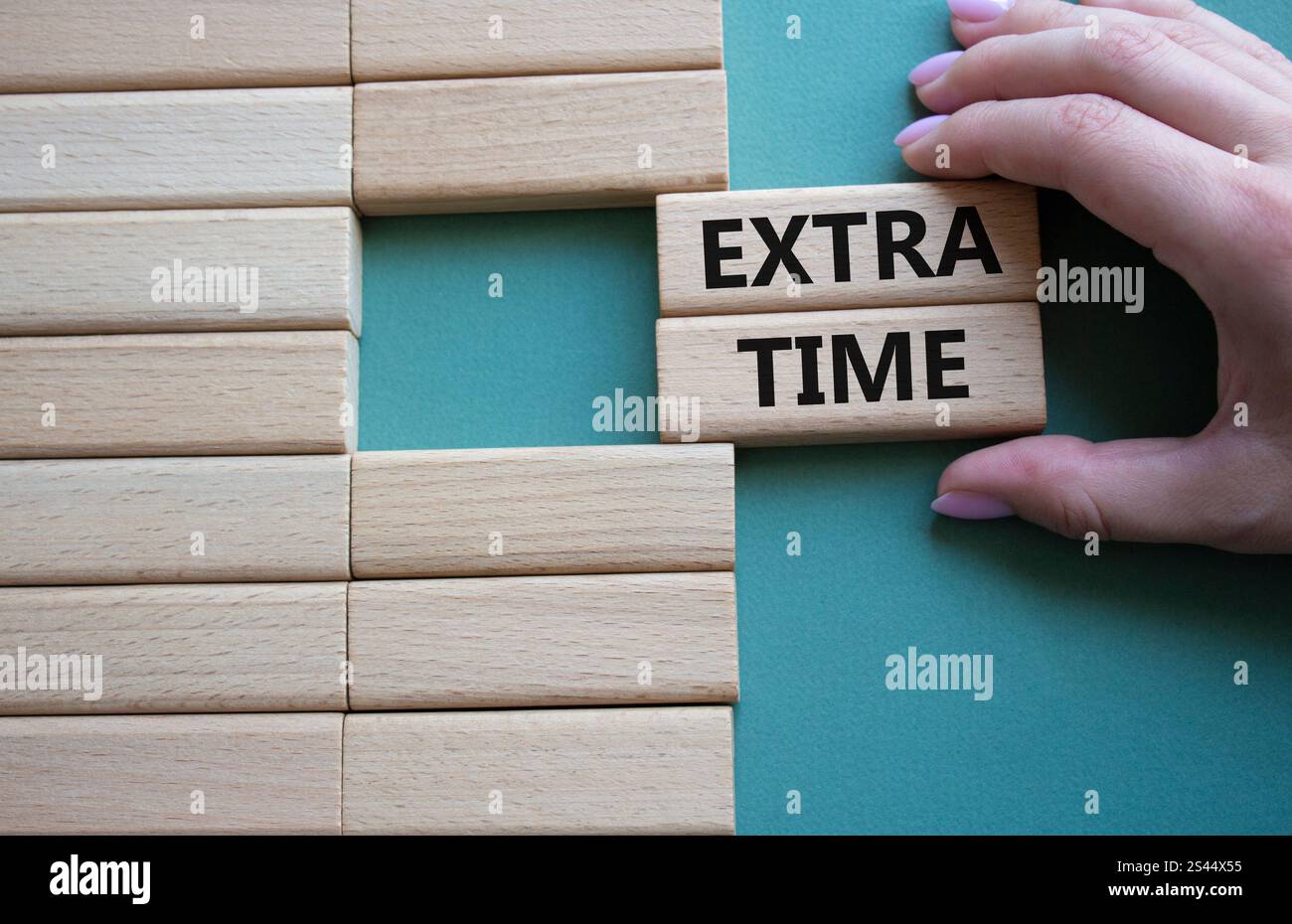 Extra time symbol. Concept word Extra time on wooden blocks ...