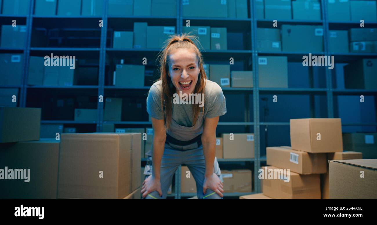 Portrait of Crazy Female Warehouse Employee Pushing Cardboard Boxes ...