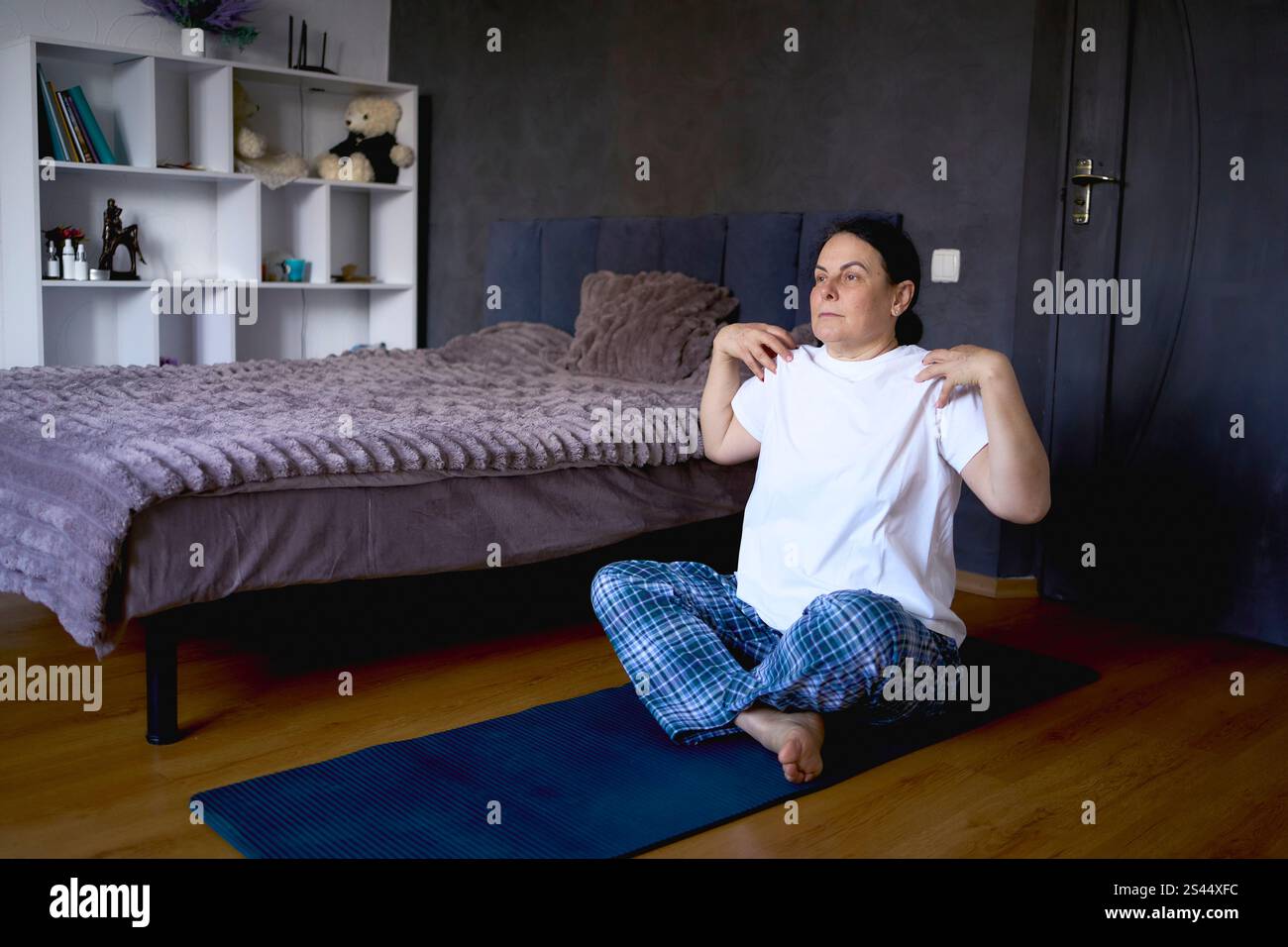 senior woman performs somatic exercises, yoga at home Stock Photo - Alamy