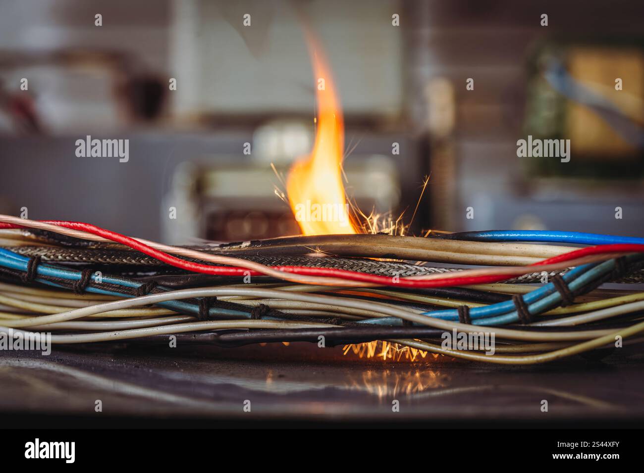 Flames, sparks, smoke between electrical cables, close up. Short ...