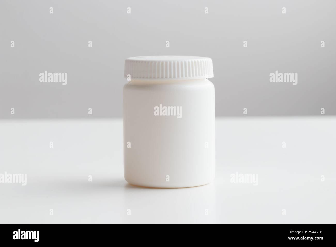 Blank white vitamin bottle. Unlabeled white nutritional supplement jar ...