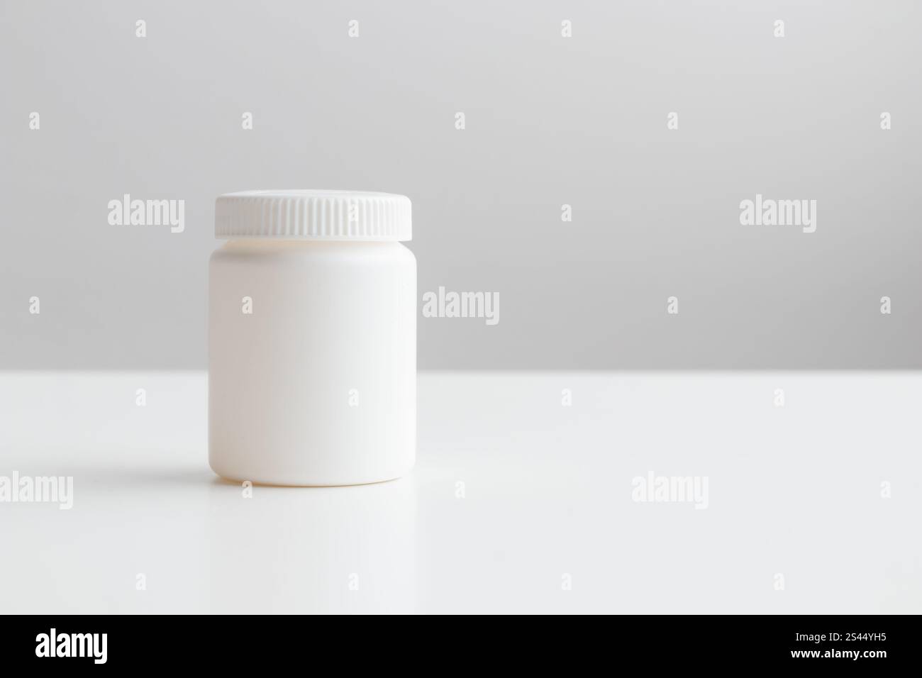 Blank white vitamin bottle. Unlabeled white nutritional supplement jar ...
