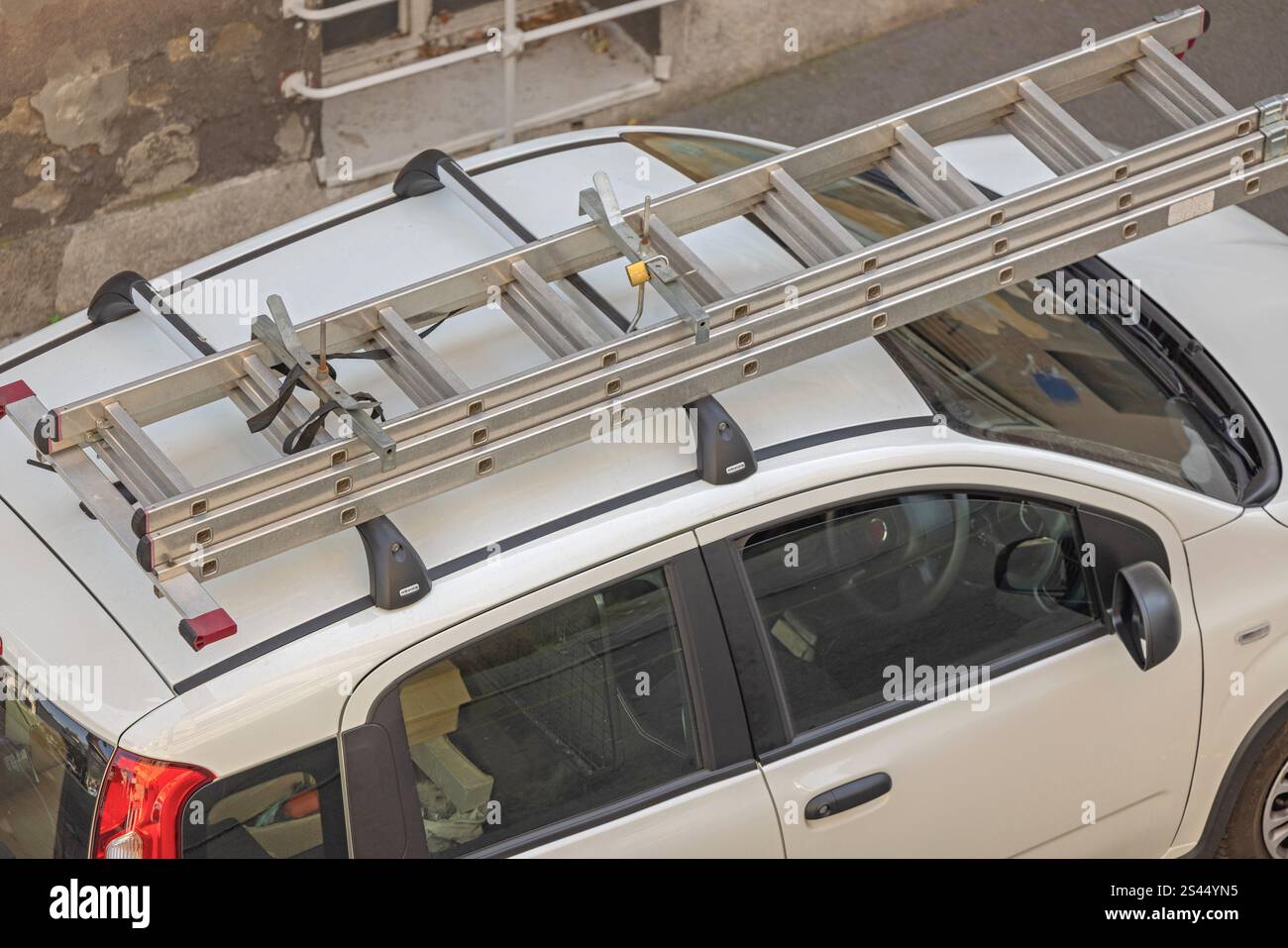 Long Ladder Locked at Top of Car Roof Rack Aerial View Stock Photo - Alamy