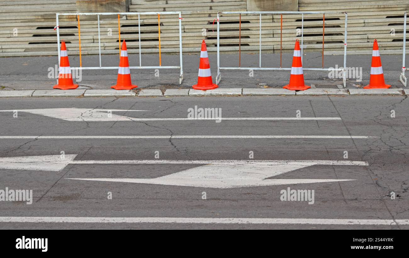 Orange Traffic Cones and Metal Fence Directional Arrows at Street Stock ...