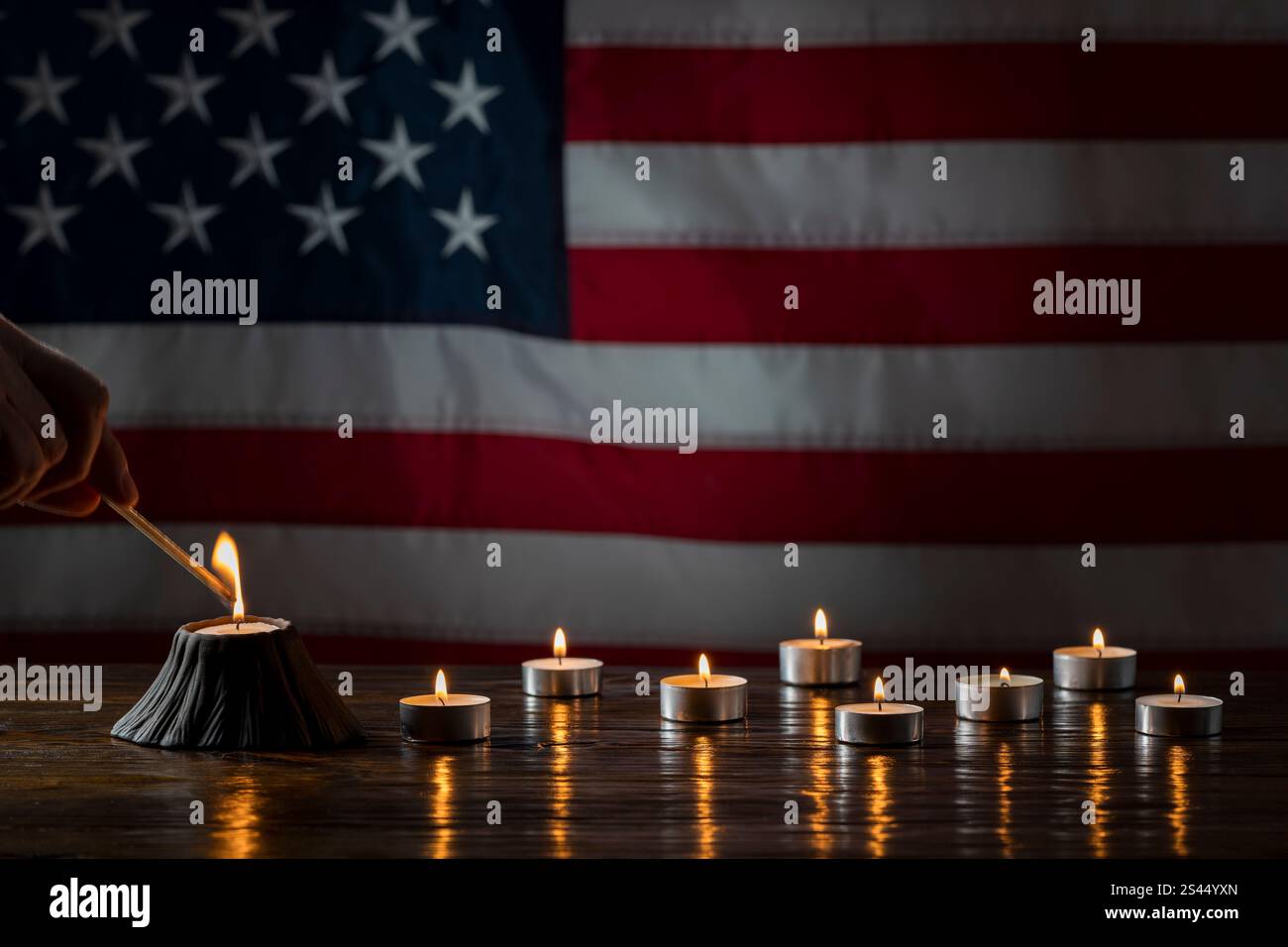 Man hand light a candle for honoring and mourning with American flag ...