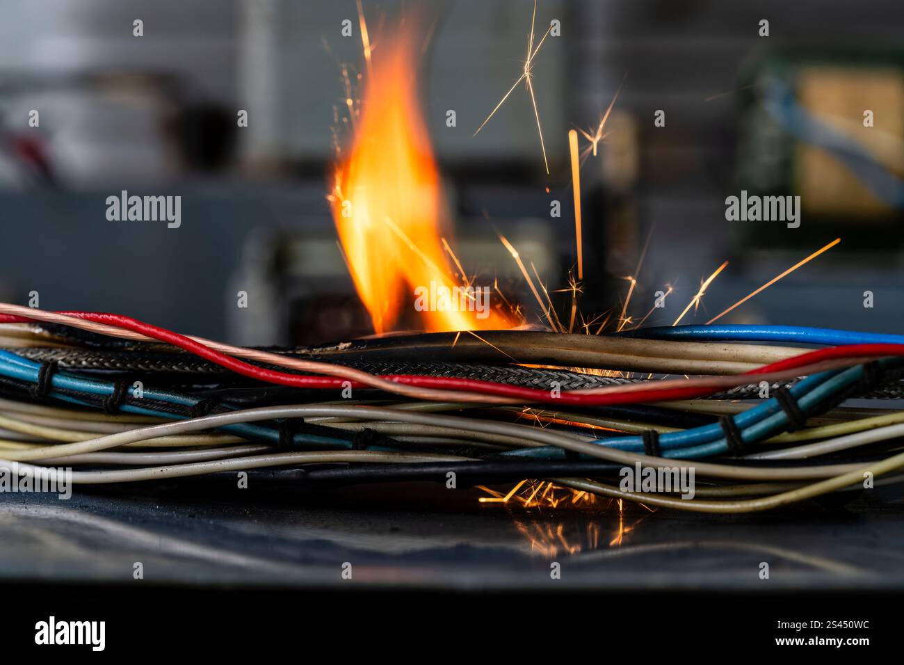 Flames, sparks, smoke between electrical cables, close up. Short ...