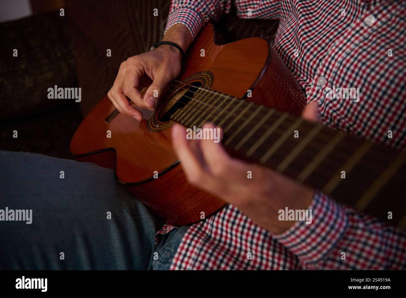 Musician plucking guitar strings in hi-res stock photography and images ...