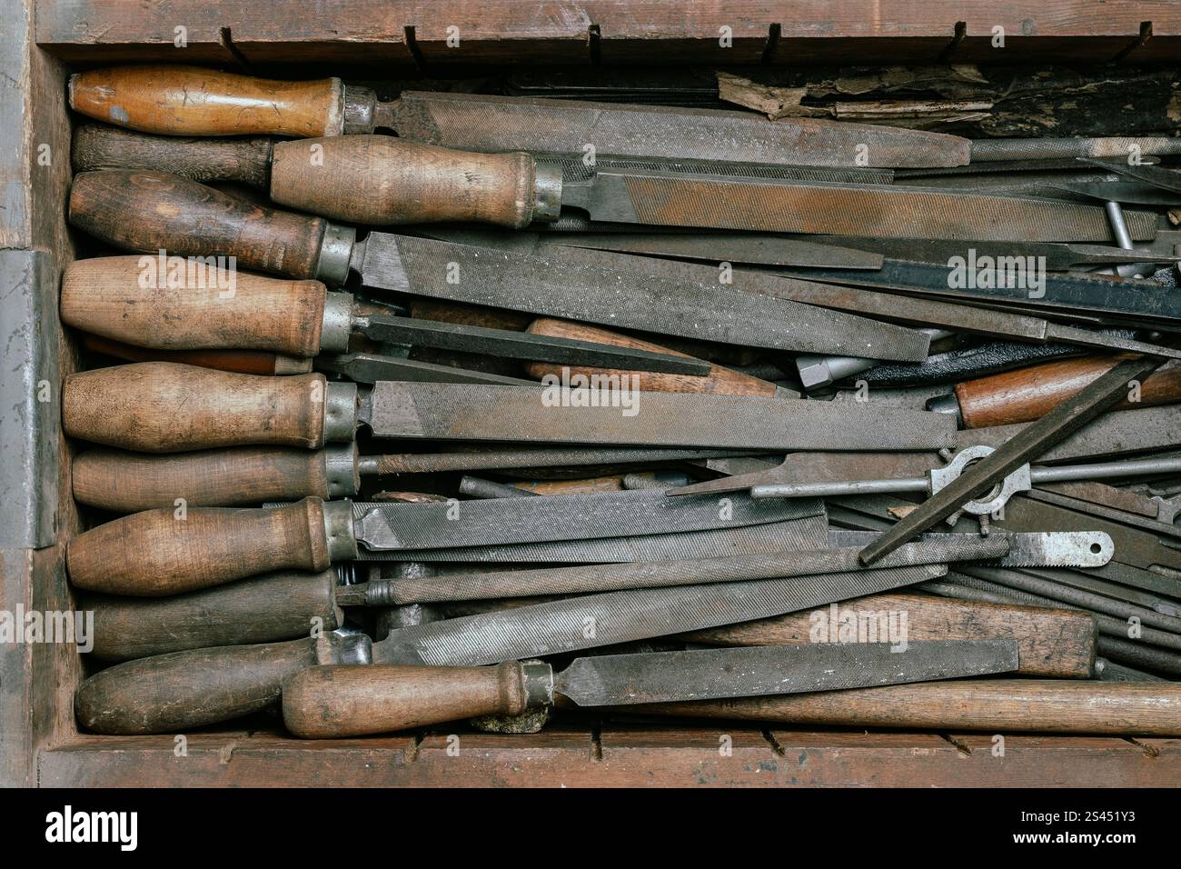 Old vintage rasps with wooden handles in wooden tool box . A set of ...