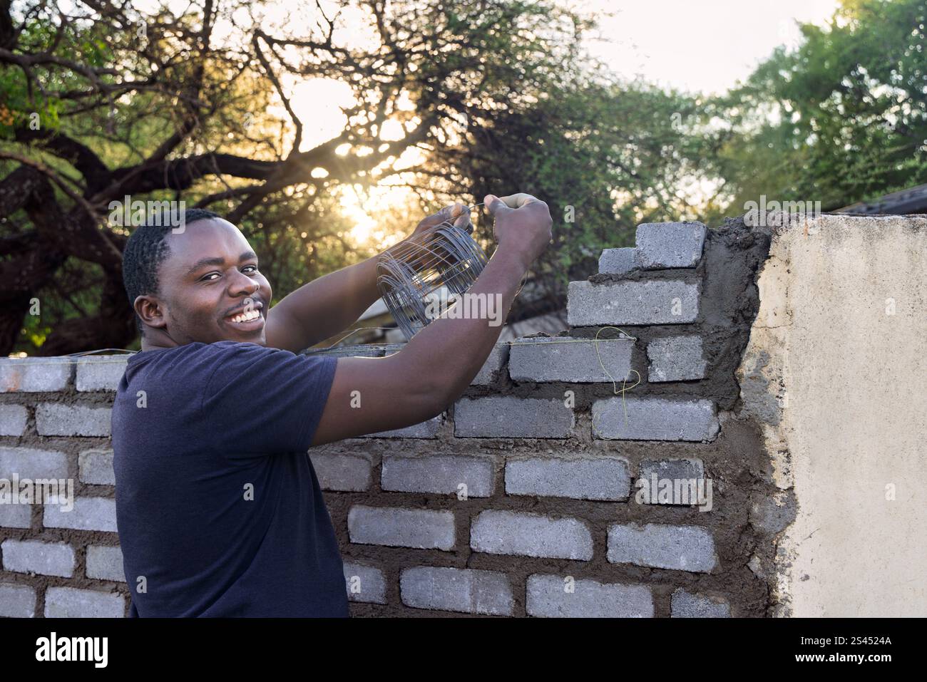 bricklayer african men, using metal masonry reinforcement to reinforce ...