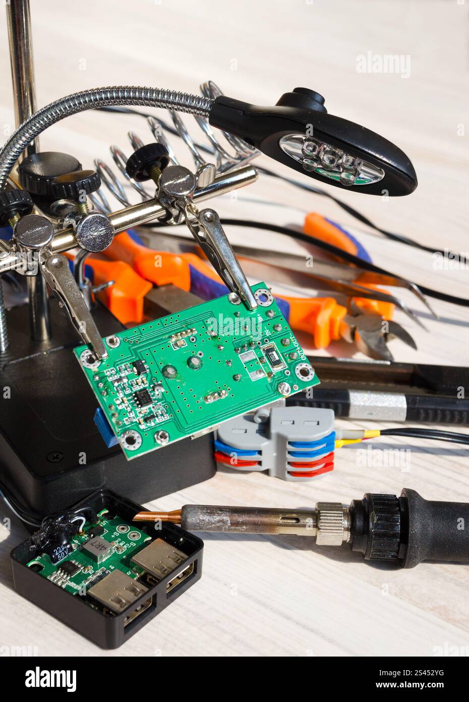 Repair tools with third hand soldering clamps. Home workshop Stock ...