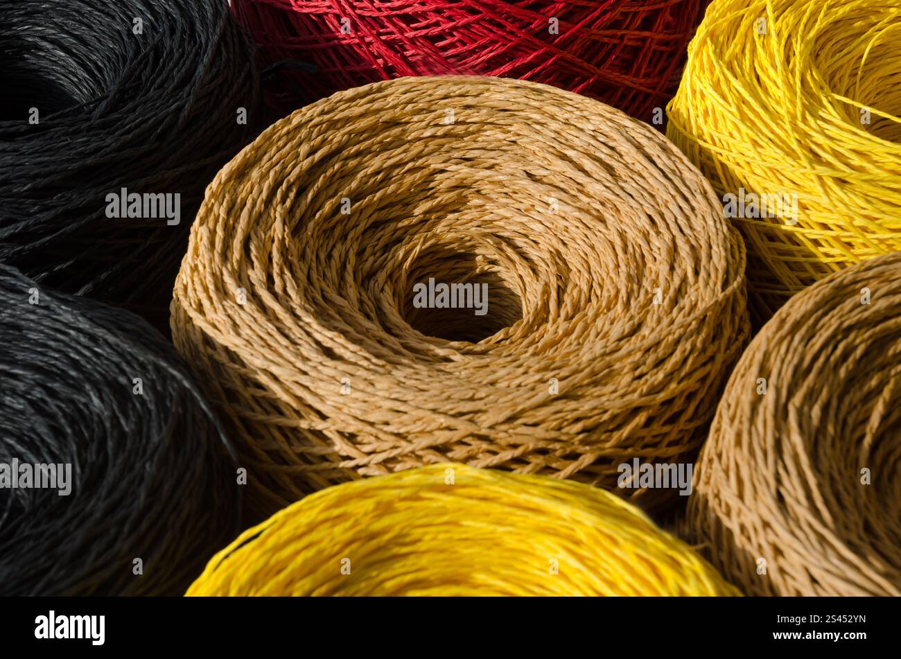Raffia balls close-up. Skeins of multi-colored raffia are ready for ...