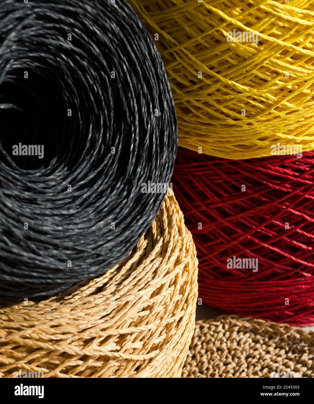 Raffia balls close-up. Skeins of multi-colored raffia are ready for ...