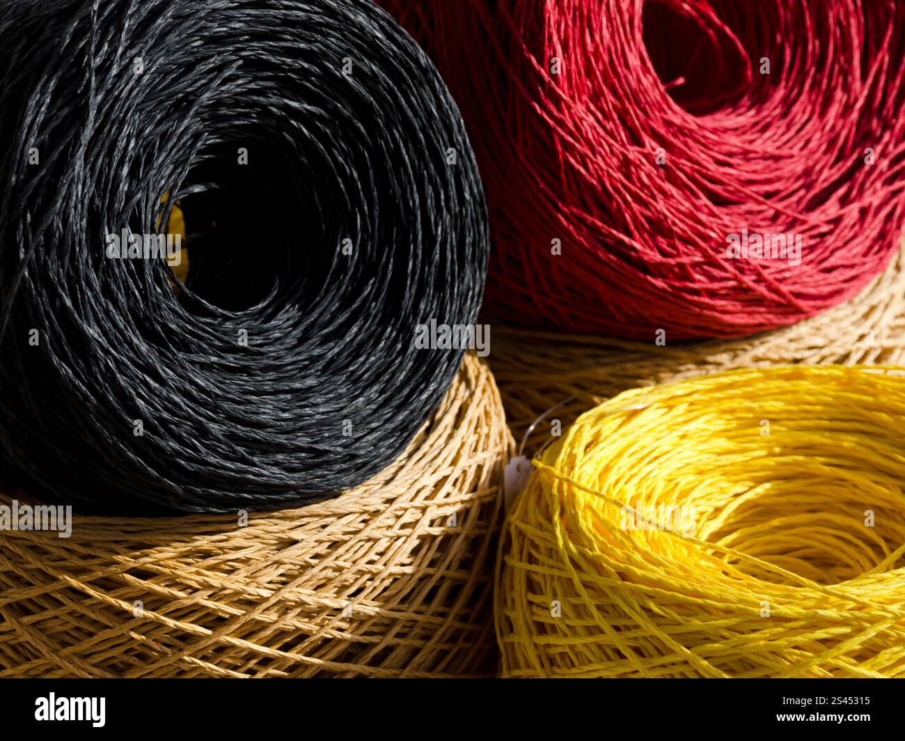 Raffia balls close-up. Skeins of multi-colored raffia are ready for ...