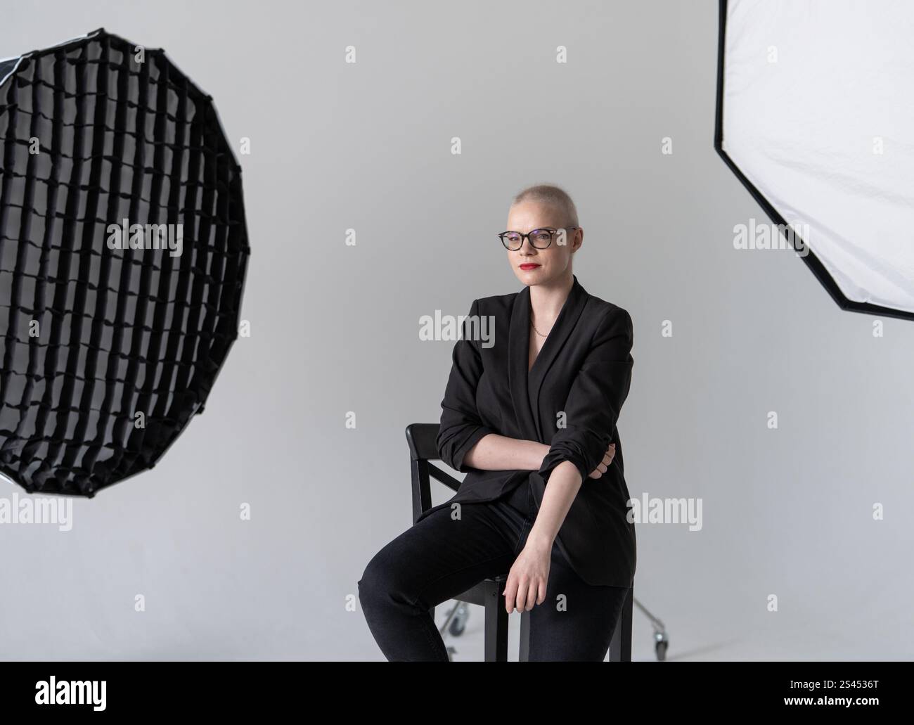 A professional woman poses confidently while seated in a photography ...